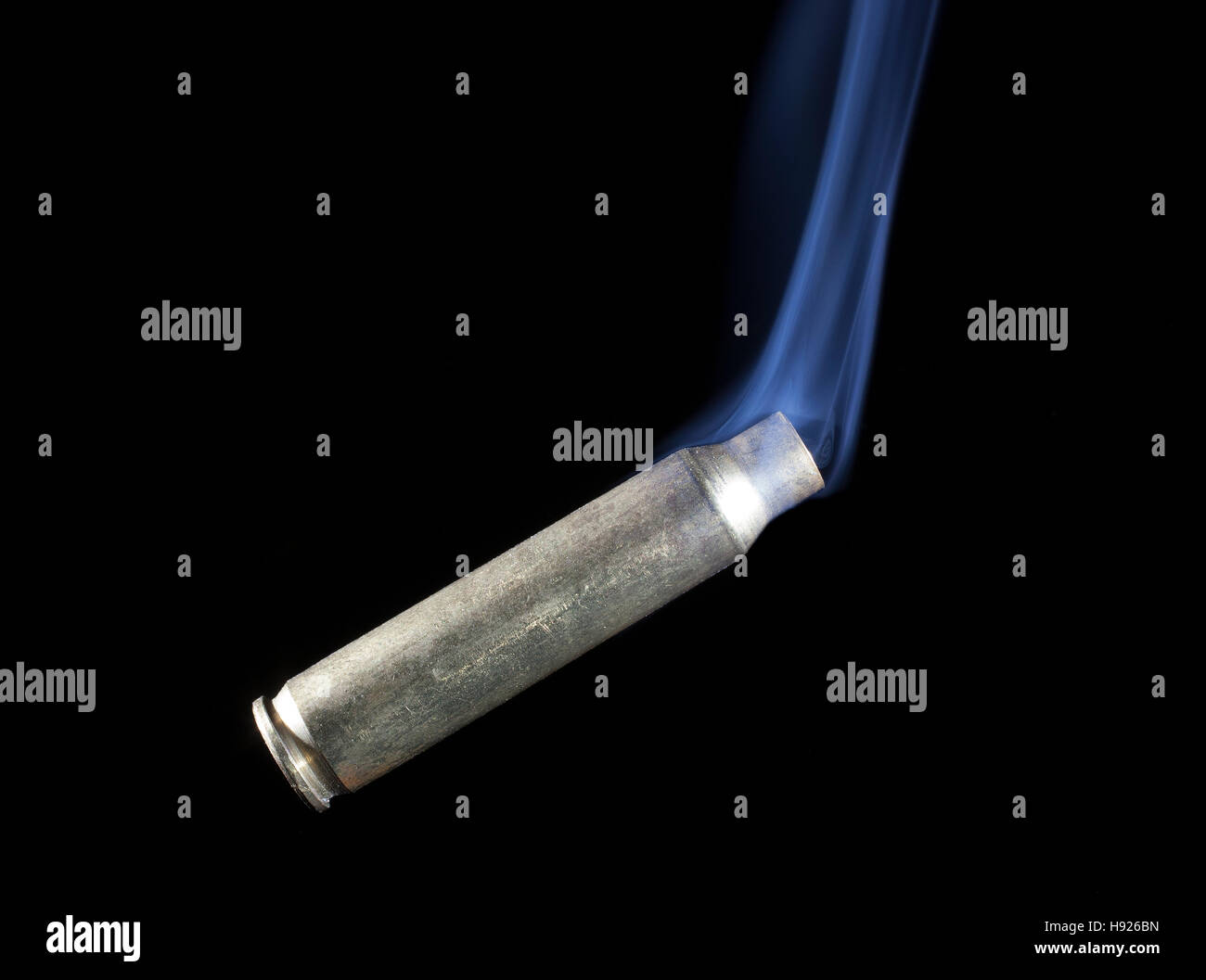 Empty rifle casing with smoke on a black background Stock Photo - Alamy