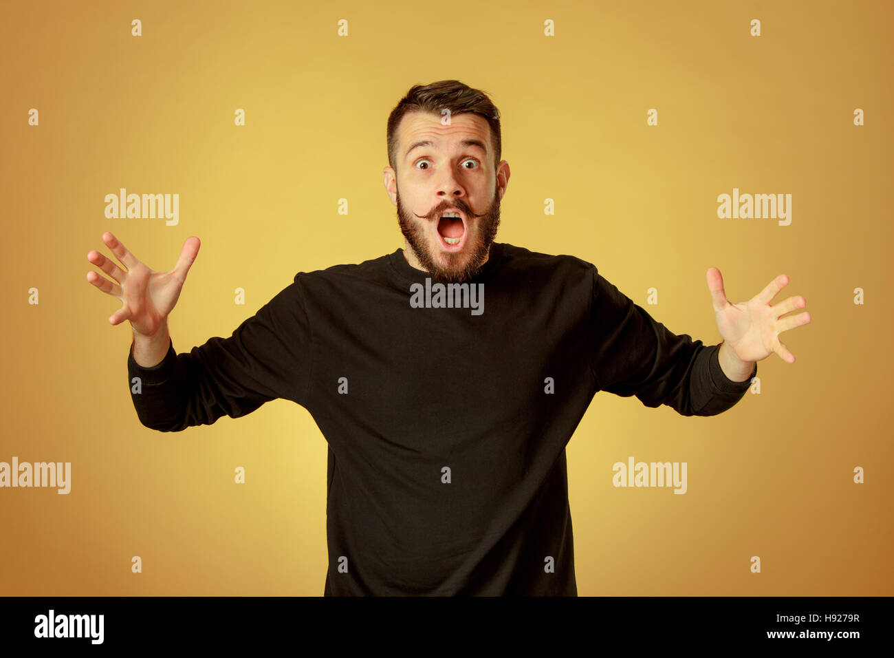 Portrait of young man with shocked facial expression Stock Photo - Alamy