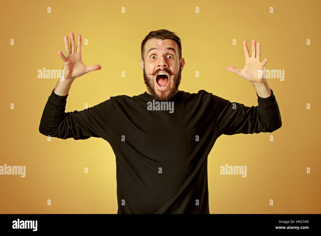 Portrait of young man with shocked facial expression Stock Photo - Alamy
