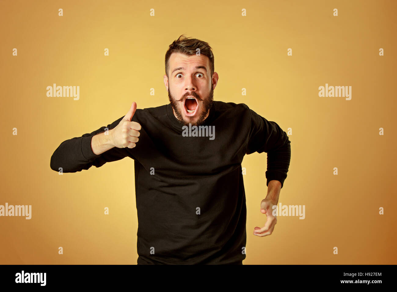 Portrait of young man with shocked facial expression Stock Photo - Alamy