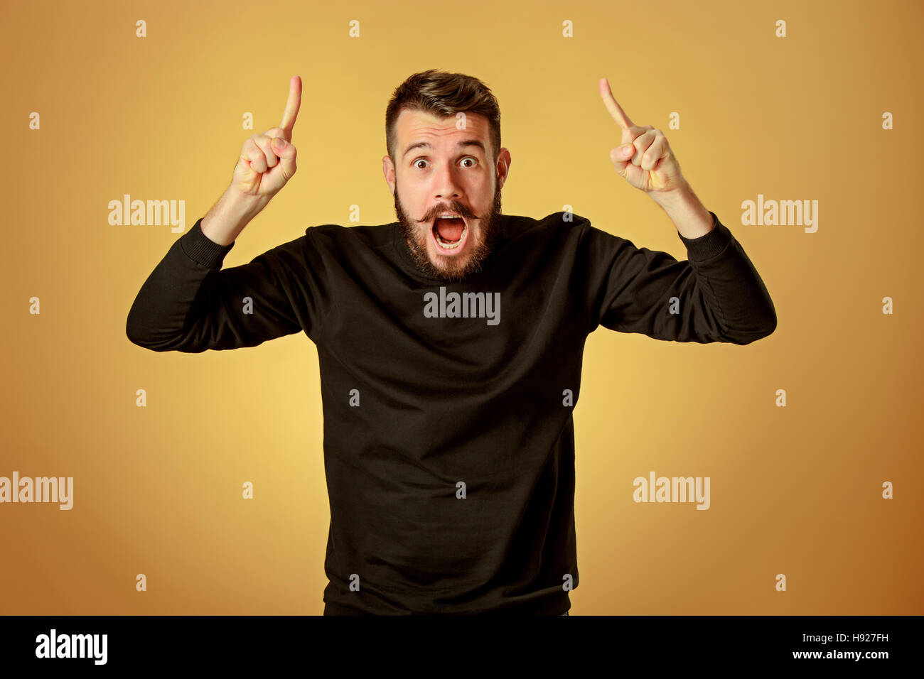 Portrait of young man with shocked facial expression Stock Photo - Alamy