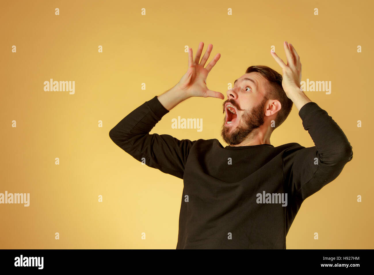 Portrait of young man with shocked facial expression Stock Photo - Alamy