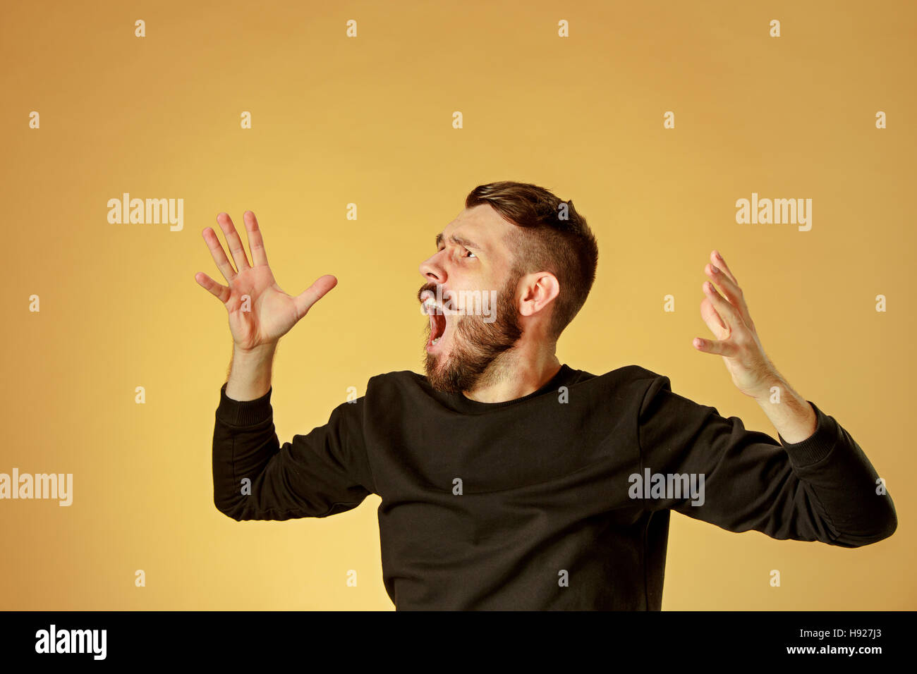 Portrait of young man with shocked facial expression Stock Photo - Alamy