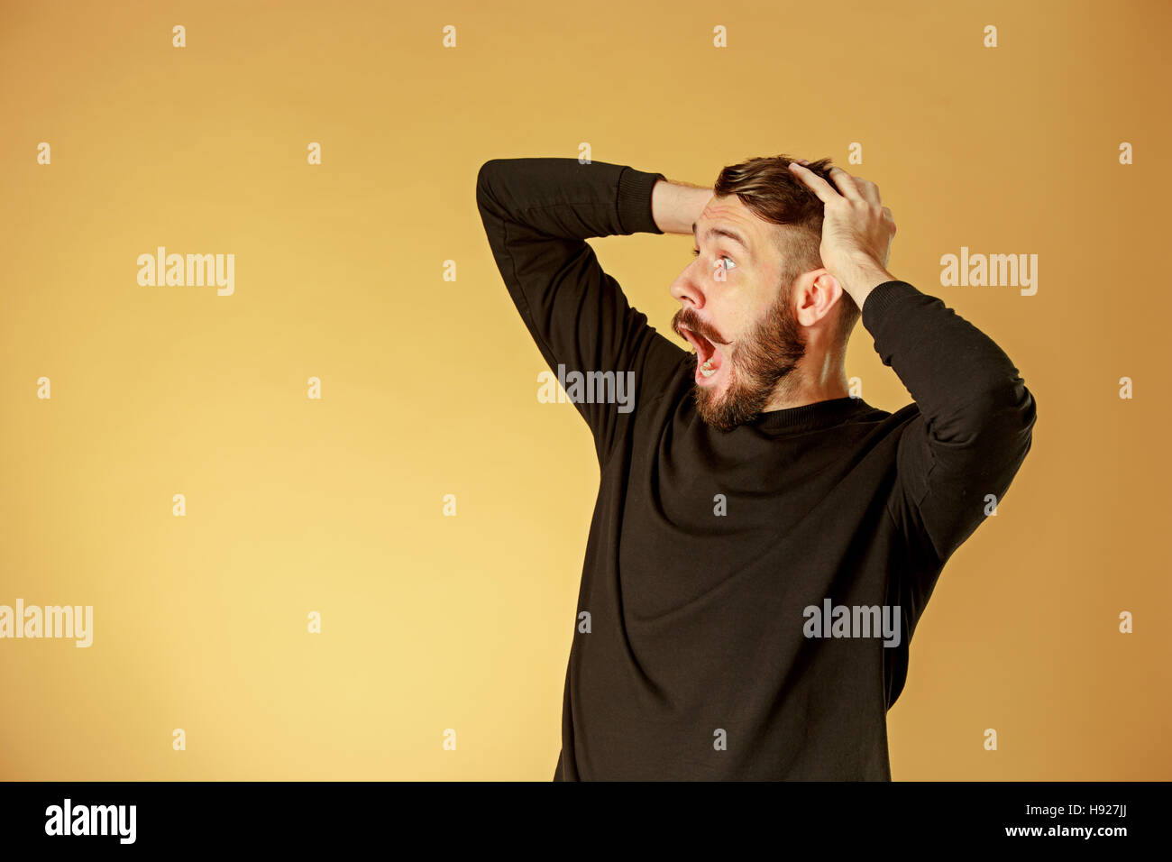 Portrait of young man with shocked facial expression Stock Photo - Alamy
