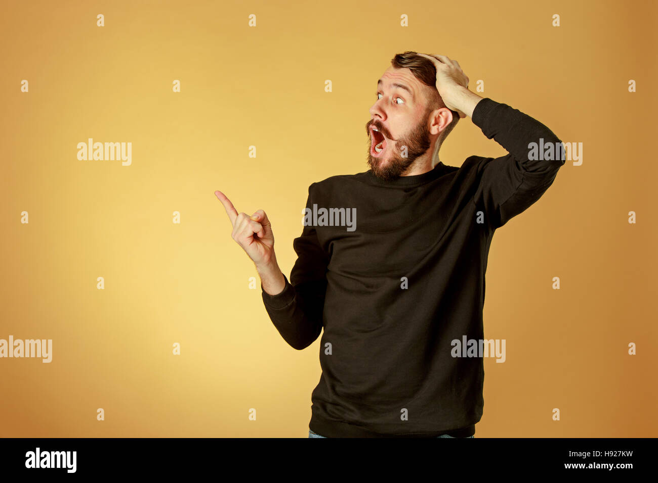 Portrait of young man with shocked facial expression Stock Photo - Alamy
