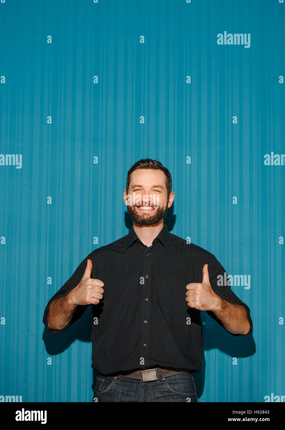 Portrait of young man with happy facial expression Stock Photo - Alamy