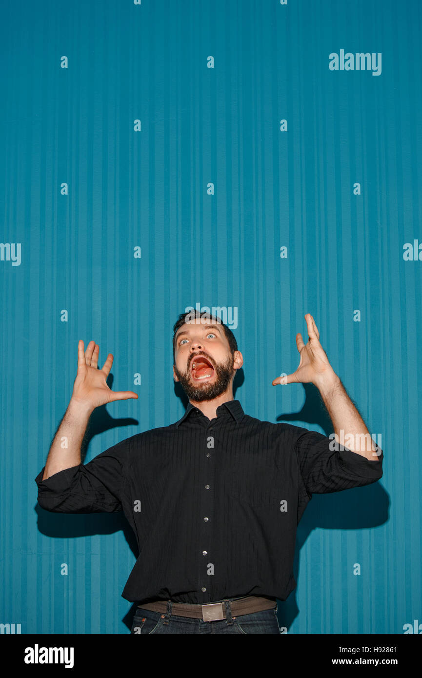 Portrait of young man with shocked facial expression Stock Photo - Alamy