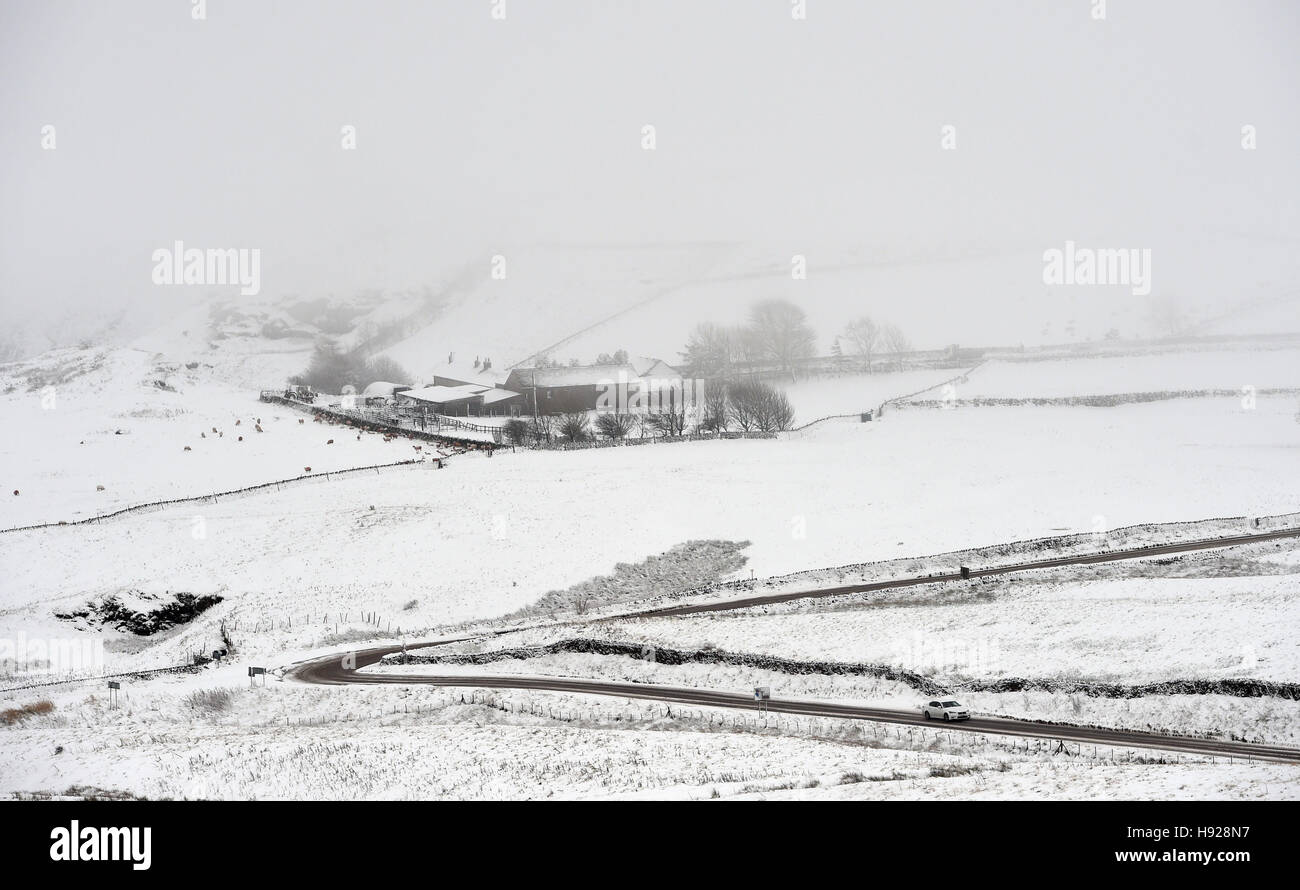 A car makes its way through the snow from Mam Tor, Derbyshire, after ...