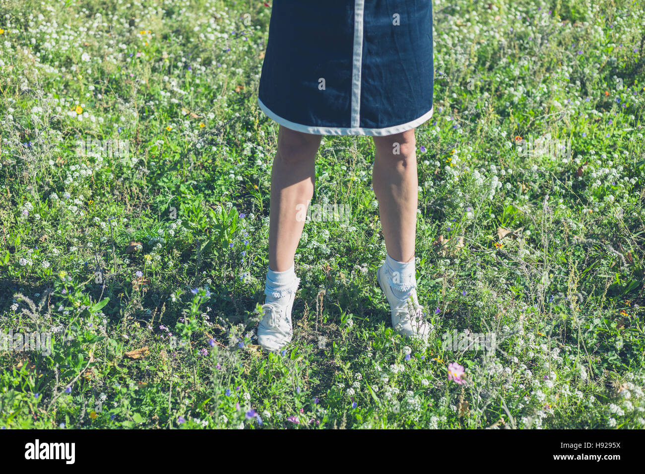 The legs of a young woman standing on her tip toes in a meadow Stock ...