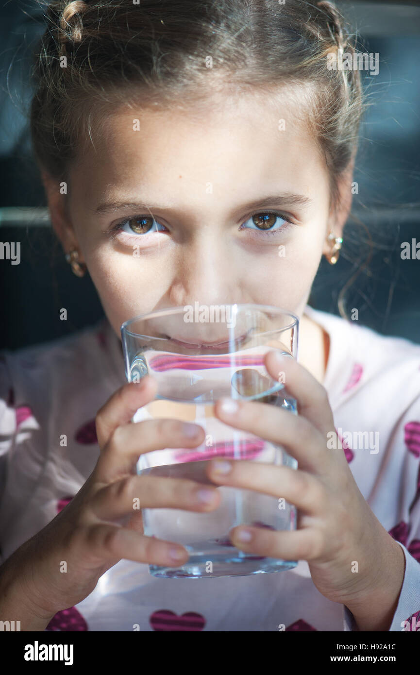 Cute little girl drinking water outdoors Stock Photo - Alamy