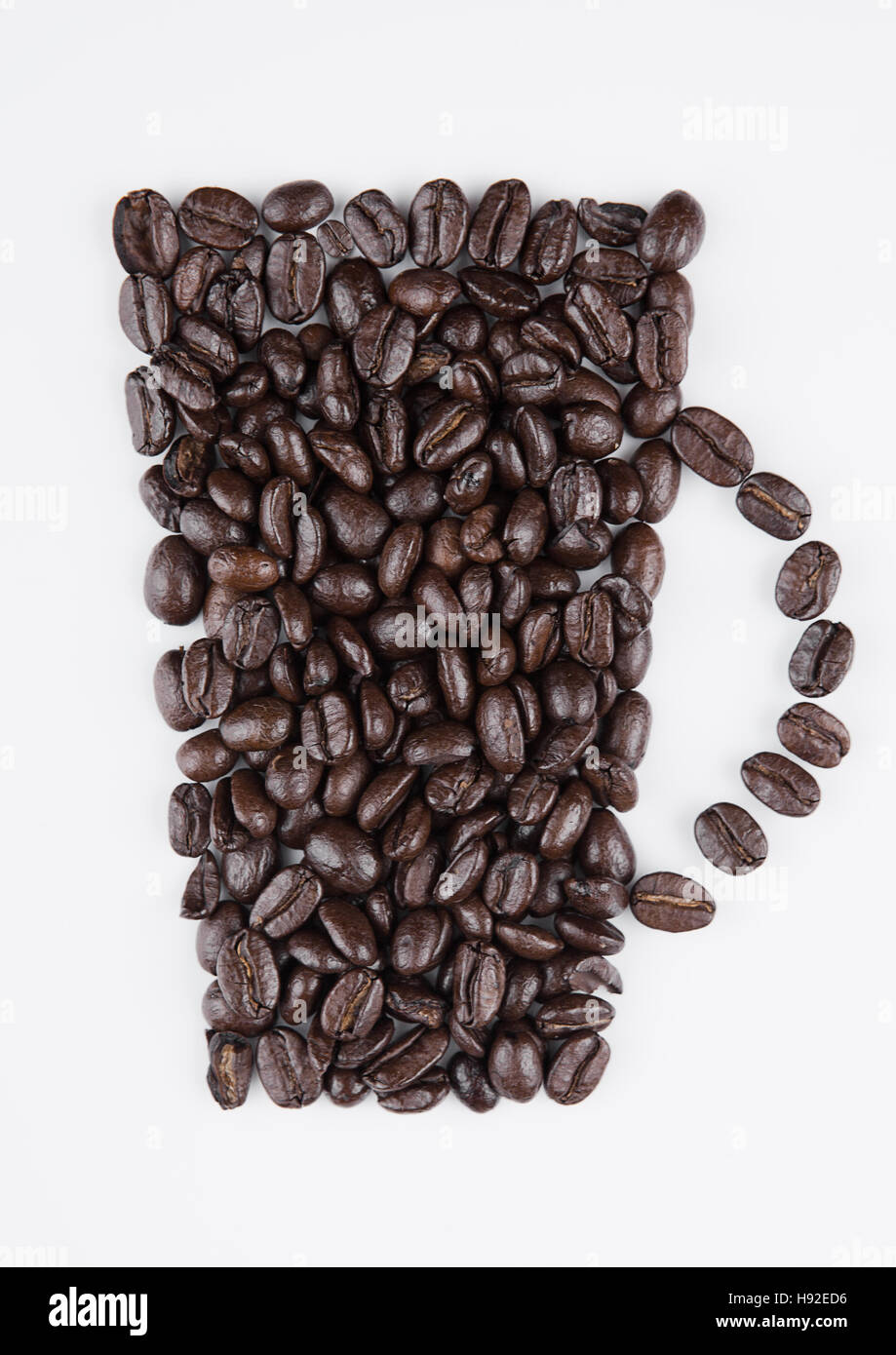 Cup of black coffee shape created from beans Stock Photo - Alamy