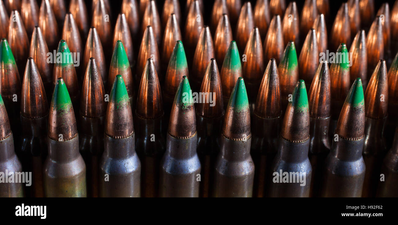 Green tipped and copper bullets with stell inserts loaded on cartridges ...