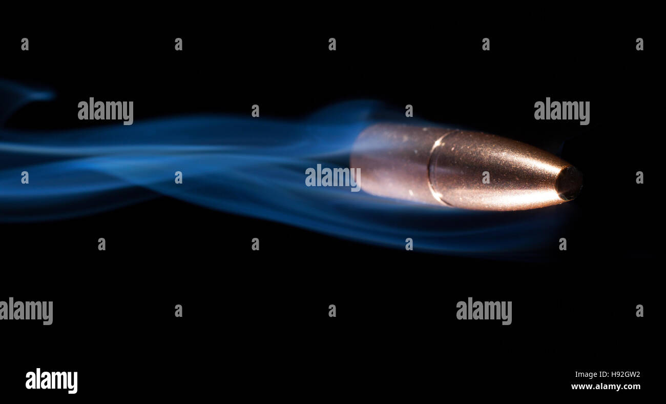 Copper jacketed bullet passing by the right of the camera Stock Photo ...