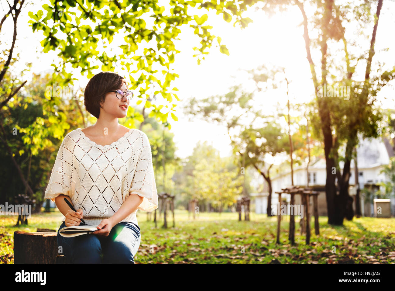 Young Woman Sitting Writing Outside Concept Stock Photo - Alamy
