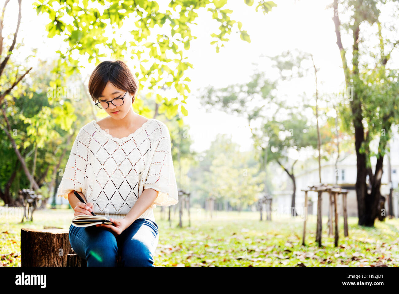 Young Woman Sitting Writing Outside Concept Stock Photo - Alamy