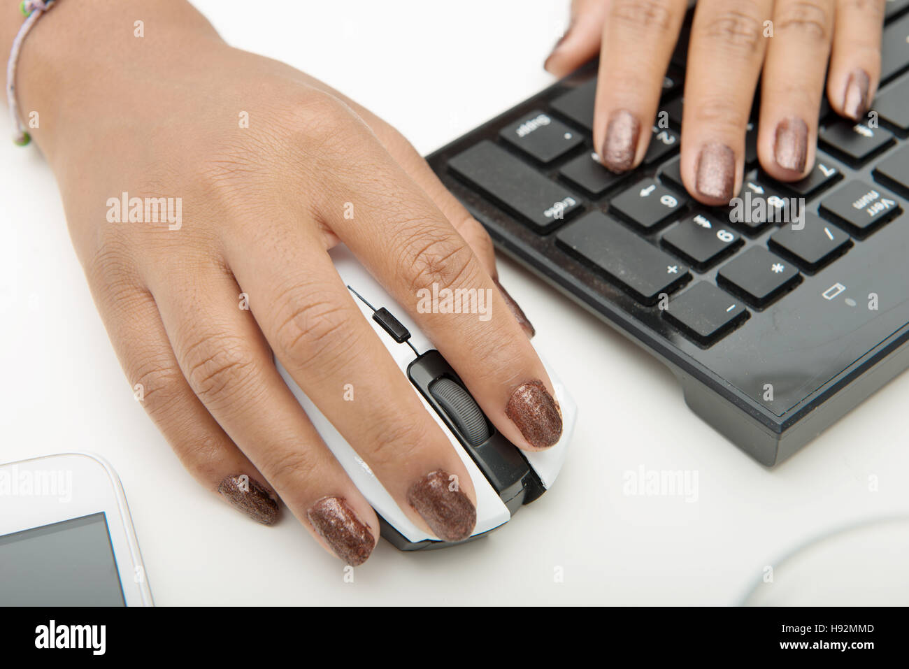 young woman using computer mouse and keyboard Stock Photo - Alamy