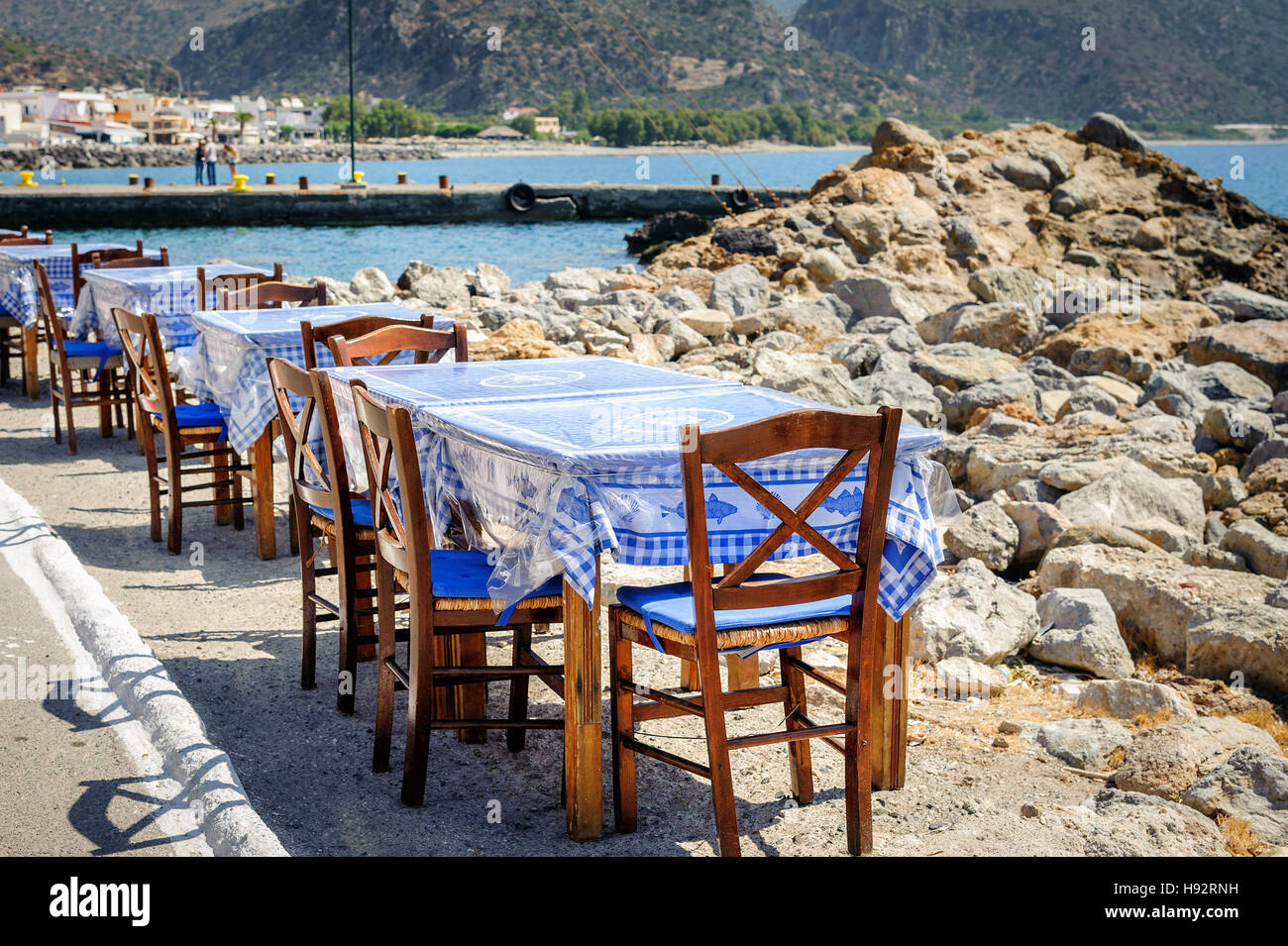 Wooden chairs and tables at traditional Greek tavern Stock Photo - Alamy