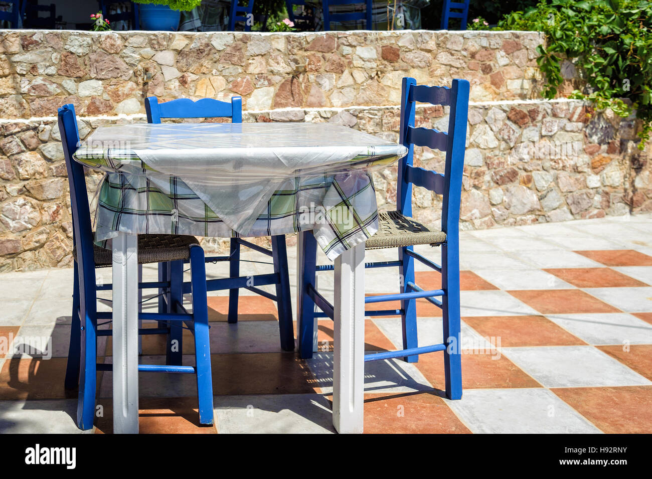 Wooden chairs and tables at traditional Greek tavern Stock Photo - Alamy