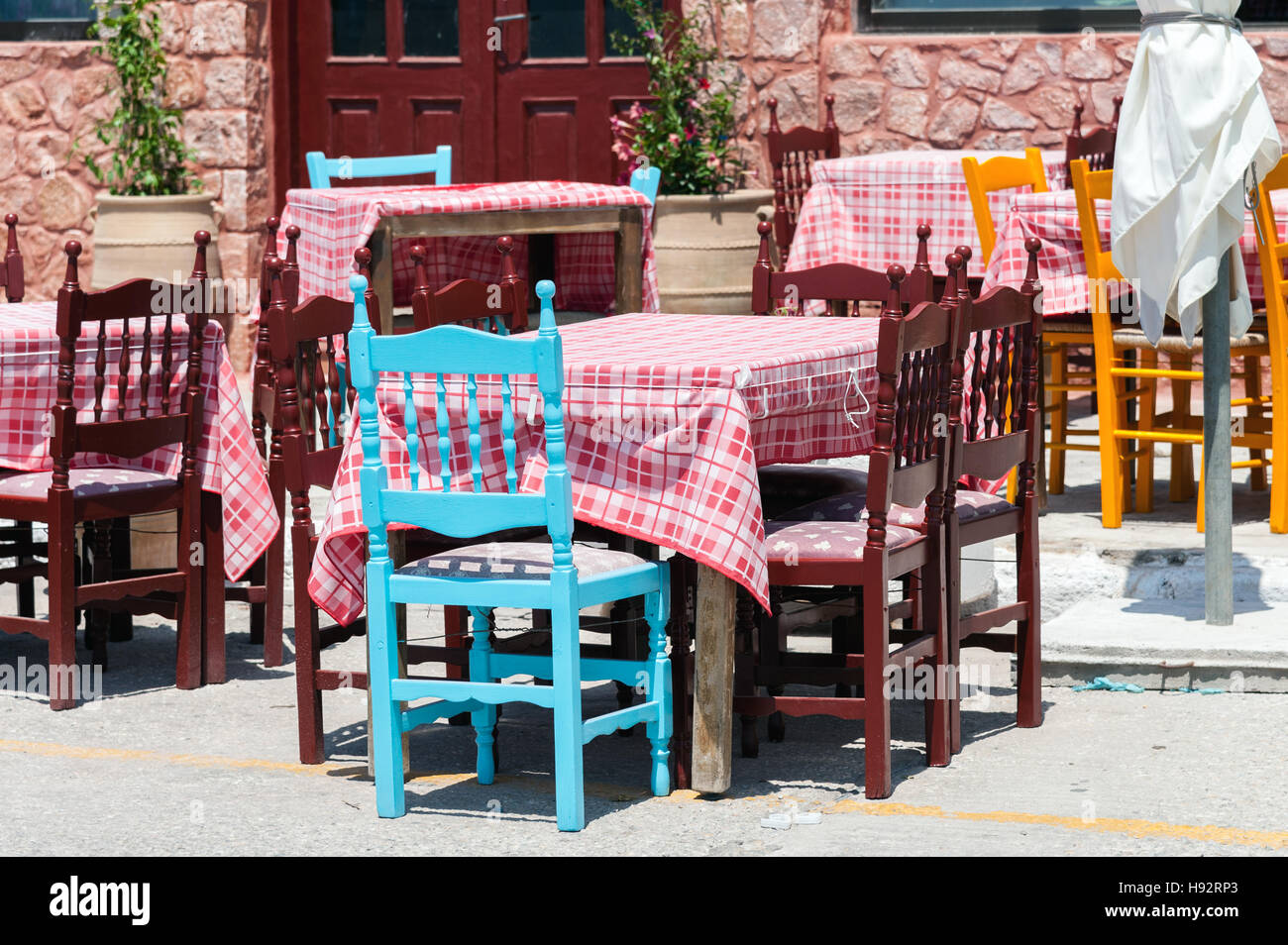 Wooden chairs and tables at traditional Greek tavern Stock Photo - Alamy