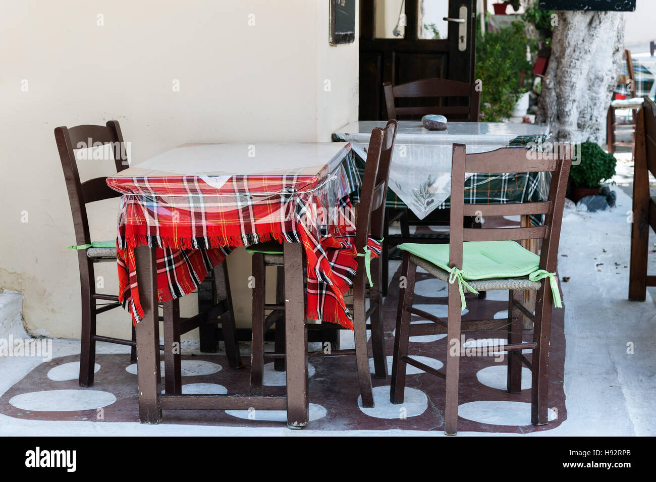 Wooden chairs and tables at traditional Greek tavern Stock Photo - Alamy