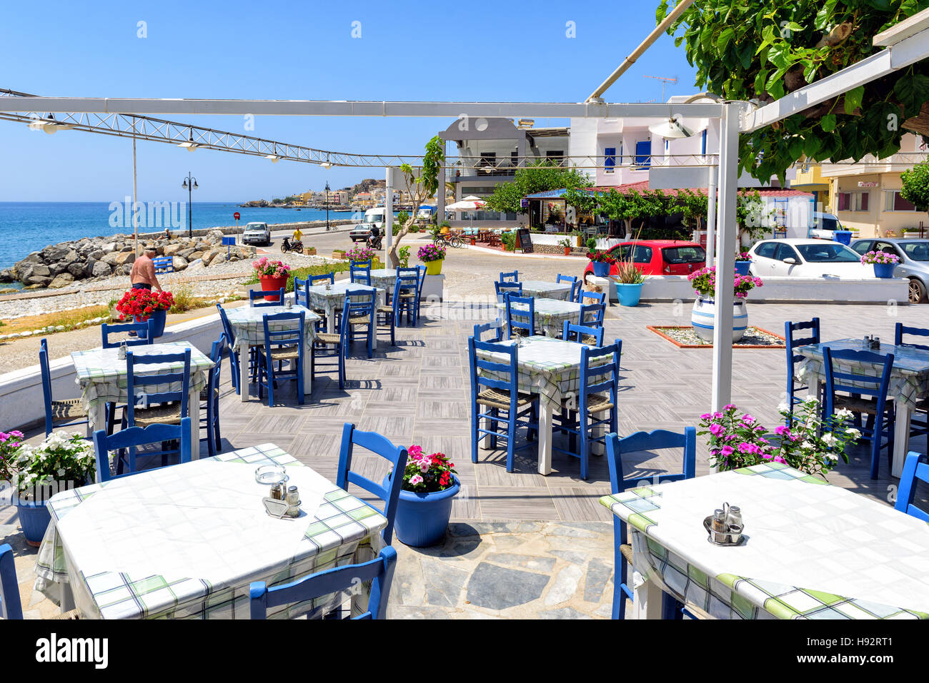 Traditional Greek tavern in traditional blue colors near the beach of ...