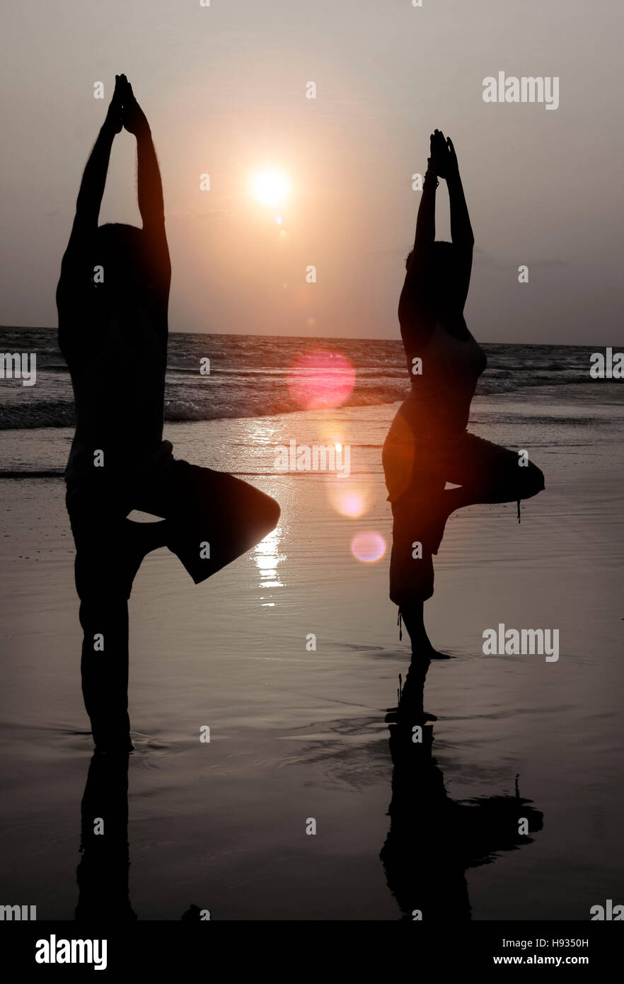 Serene People In The Beach Doing Yoga In The Sunset Concept Stock Photo ...