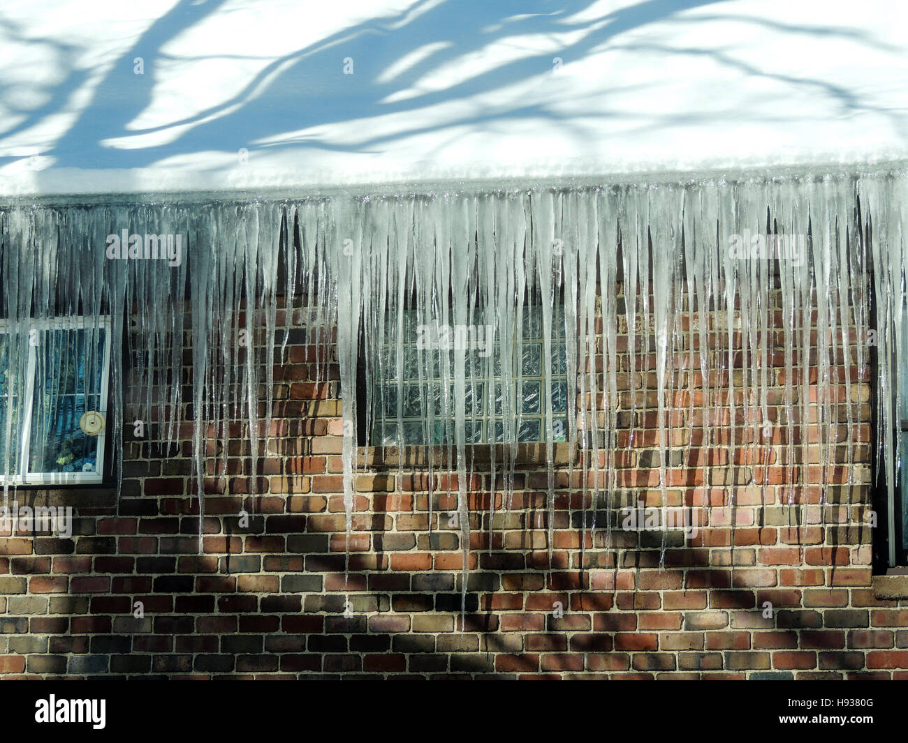 Many icicles hanging from roof Stock Photo - Alamy