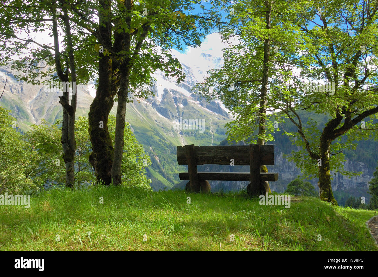 Bench with a magnificent view in a small park the Swiss alps near ...