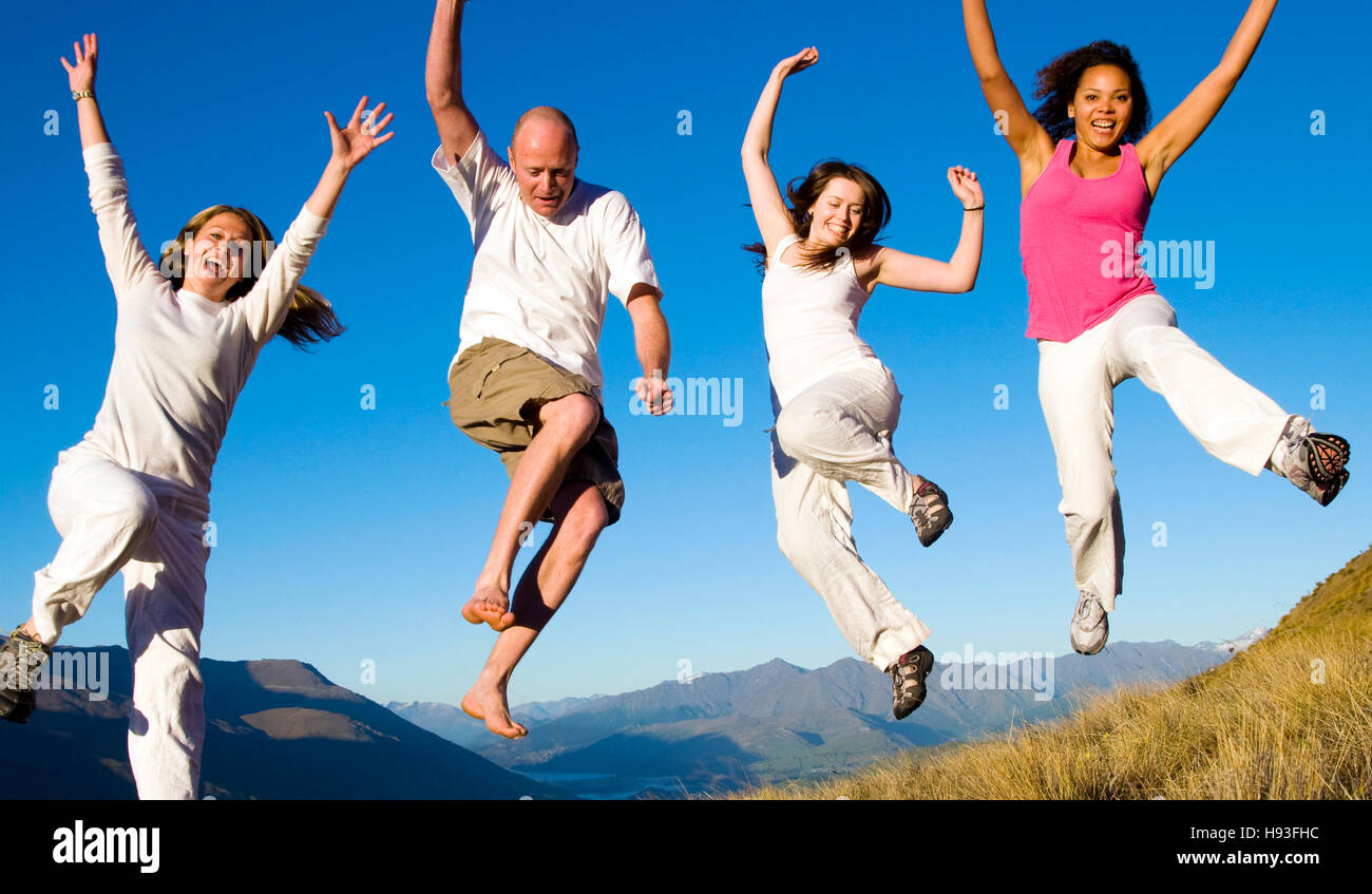 Group of young people jumping in the field Concept Stock Photo - Alamy