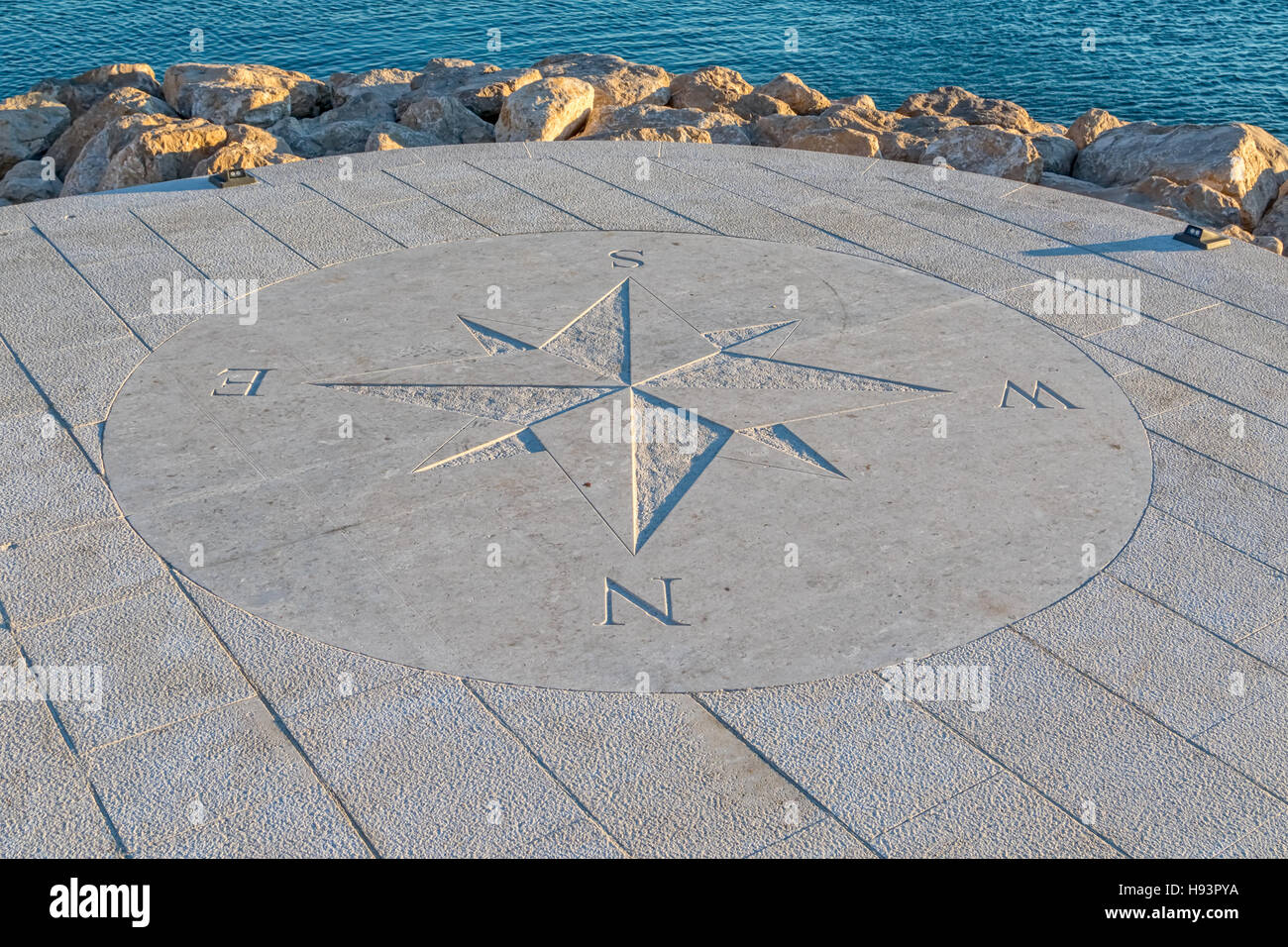 Stone compass by the sea Stock Photo - Alamy