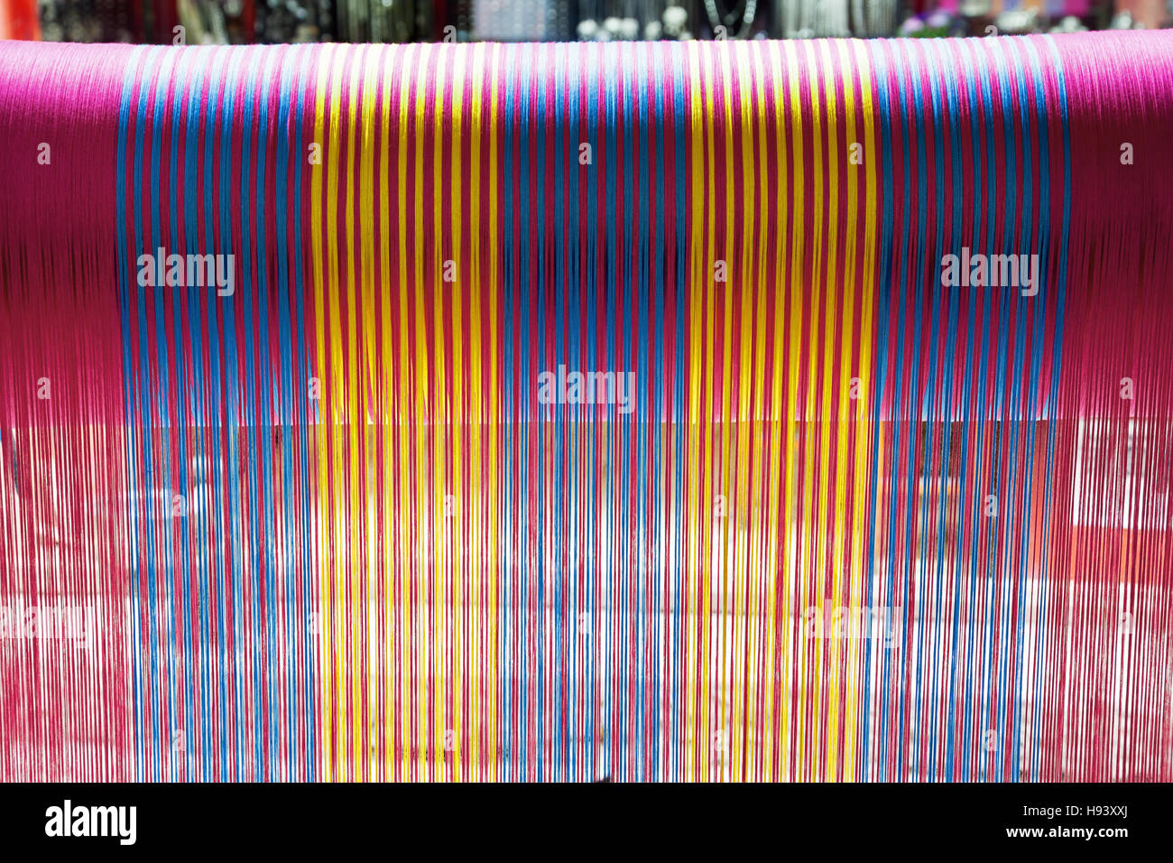 Multicolored threads on a weaving loom Stock Photo - Alamy