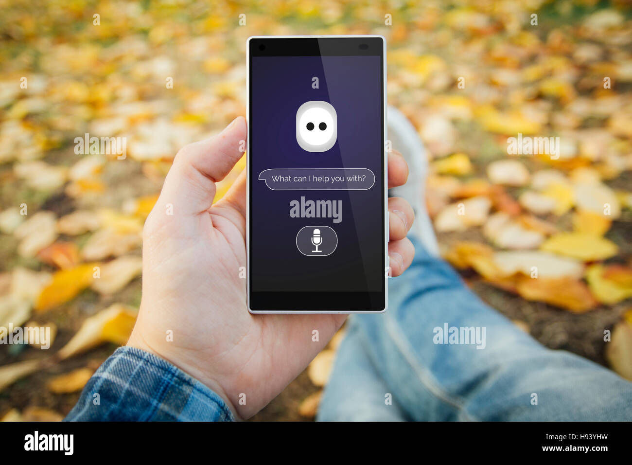 man in the park using intelligent personal assistant of his mobile. All ...