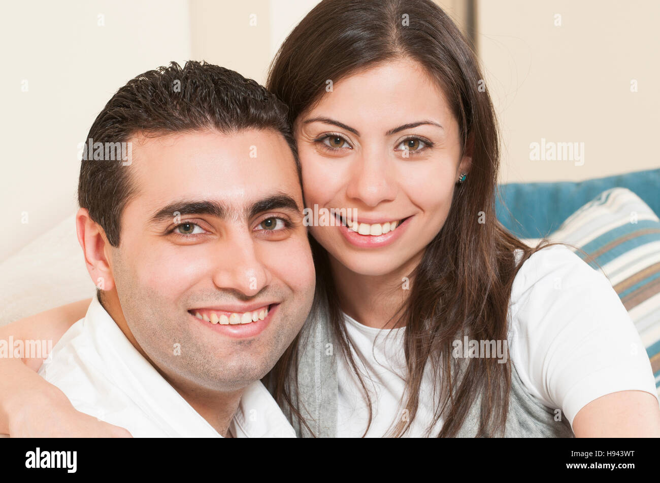 Happy couple sitting together on the sofa Stock Photo - Alamy