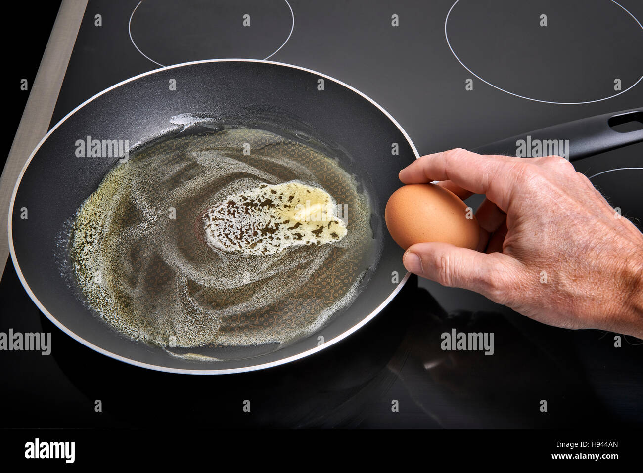 Hand frying eggs pan hi-res stock photography and images - Alamy