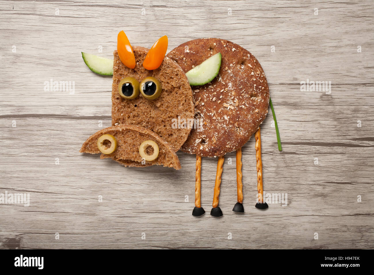 Funny bread cow made on wooden background Stock Photo - Alamy