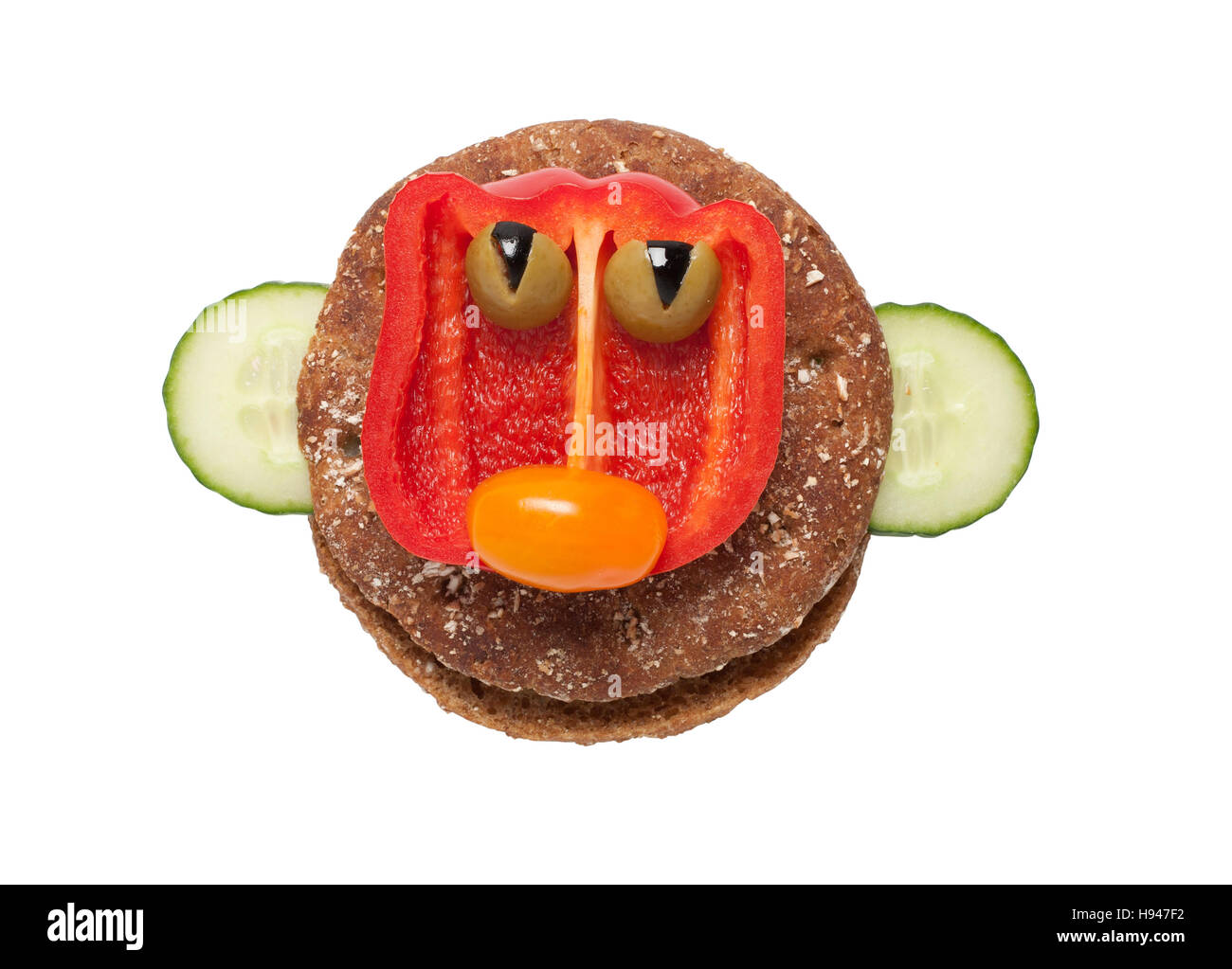 Funny face made of black bread and vegetables on white background Stock ...