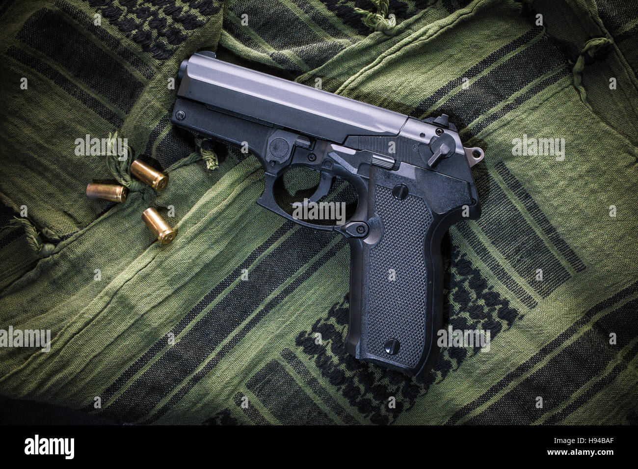 Gun on Green Kefiah Stock Photo - Alamy