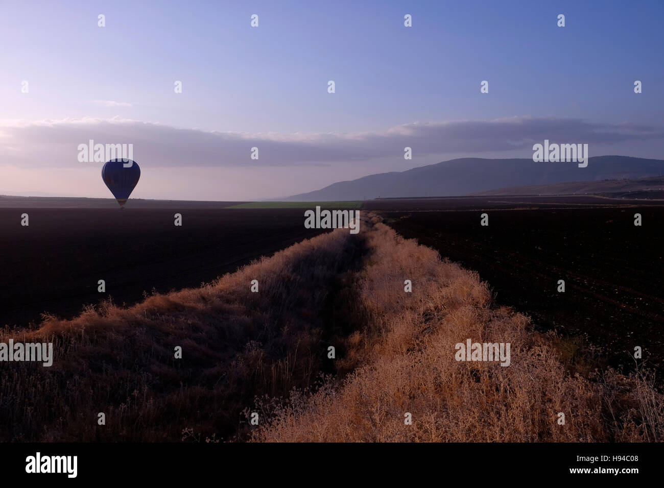 A hot air balloon hovering over agriculture fields in Jezreel Valley a ...