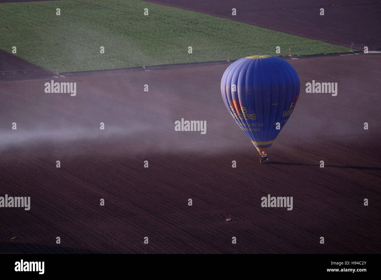 A hot air balloon hovering over agriculture fields in Jezreel Valley a ...