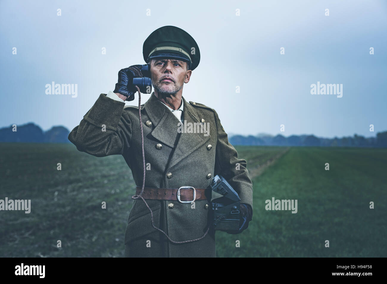 Vintage 1940s military officer calling with field phone while standing ...