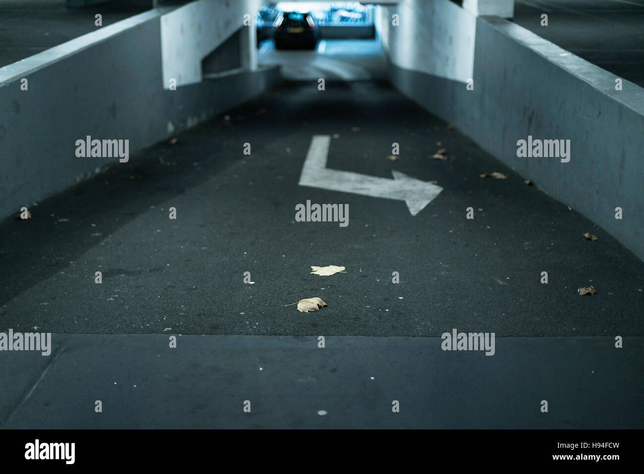 Left arrow sign on driving lane of garage Stock Photo - Alamy