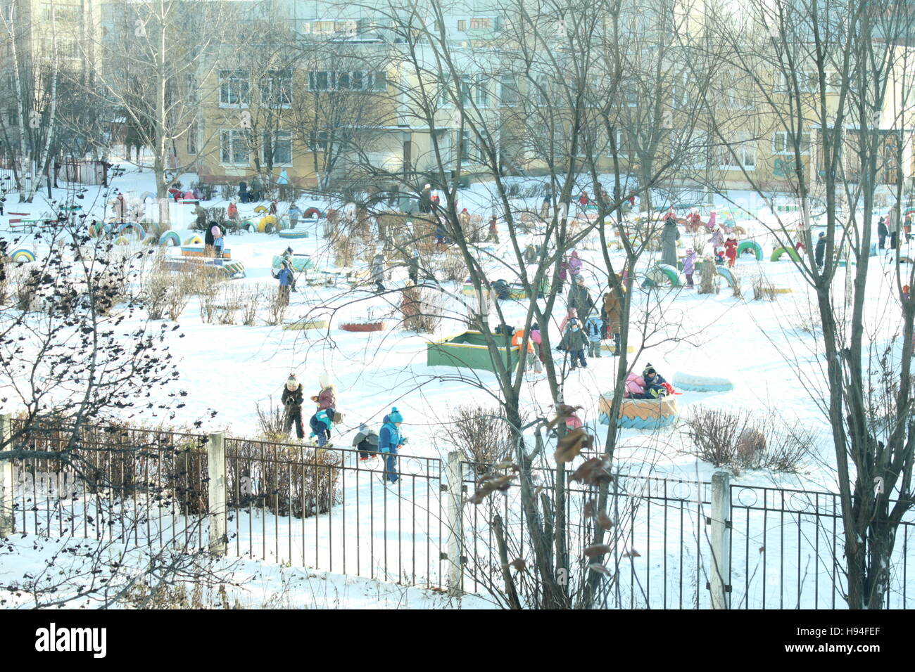 many children playing and running around in the winter Stock Photo - Alamy