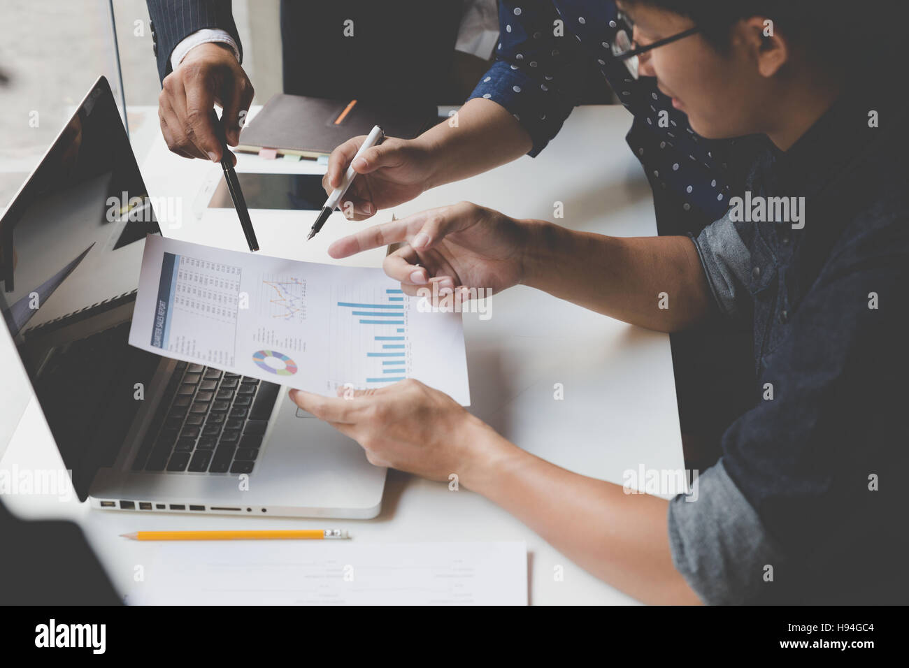 people working with document and laptop computer - meeting in office ...