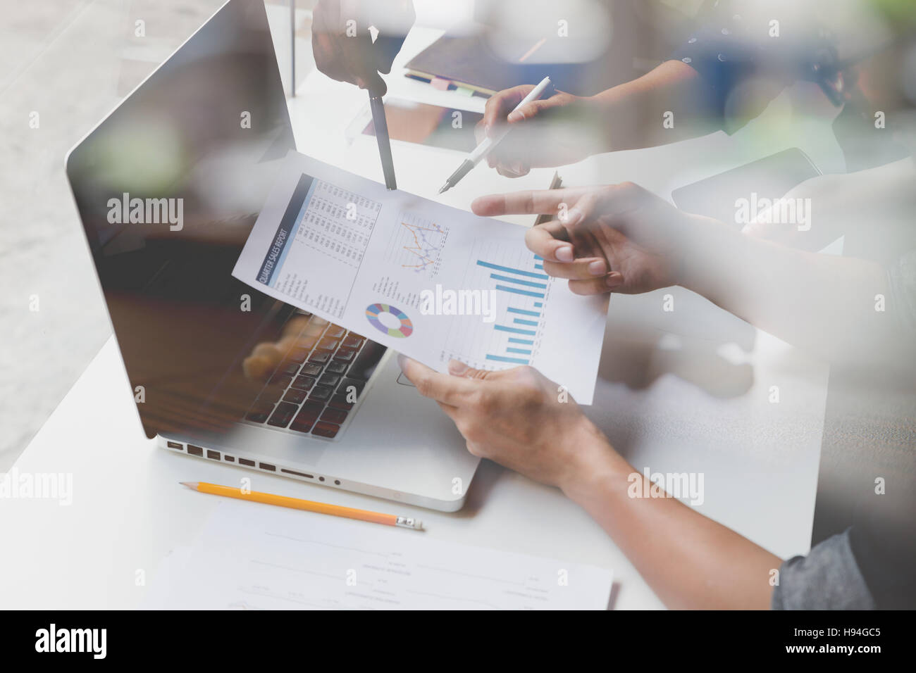people working with document and laptop computer - meeting in office ...