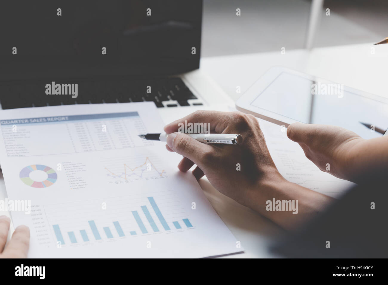 people working with document and laptop computer - meeting in office ...