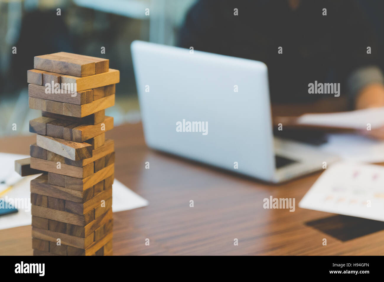 wood blocks stack game with background of businessman working in office ...