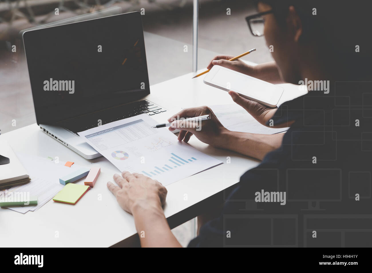 people working with document and laptop computer - meeting in office ...