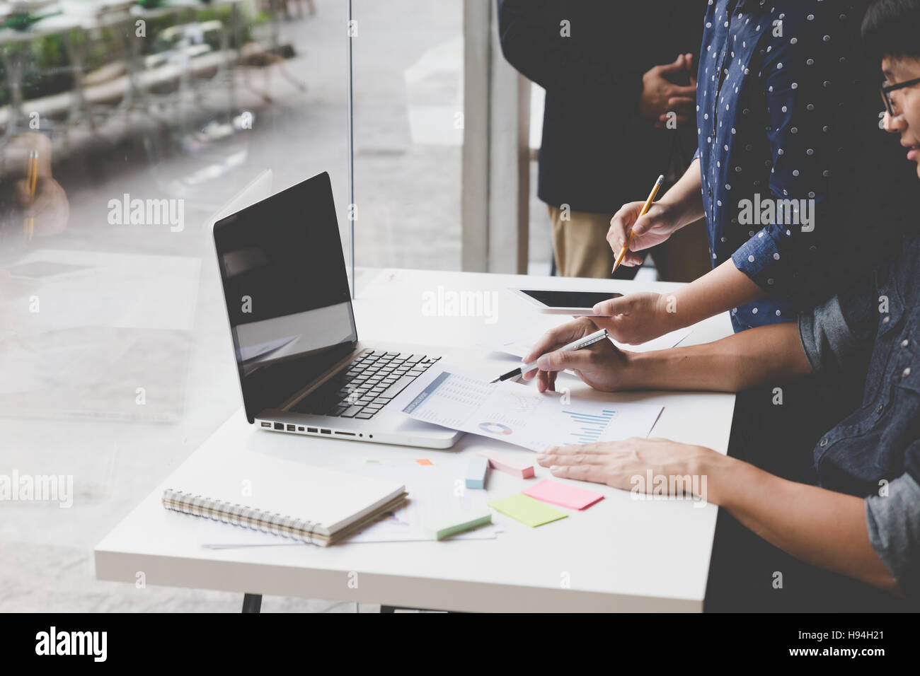 people working with document and laptop computer - meeting in office ...