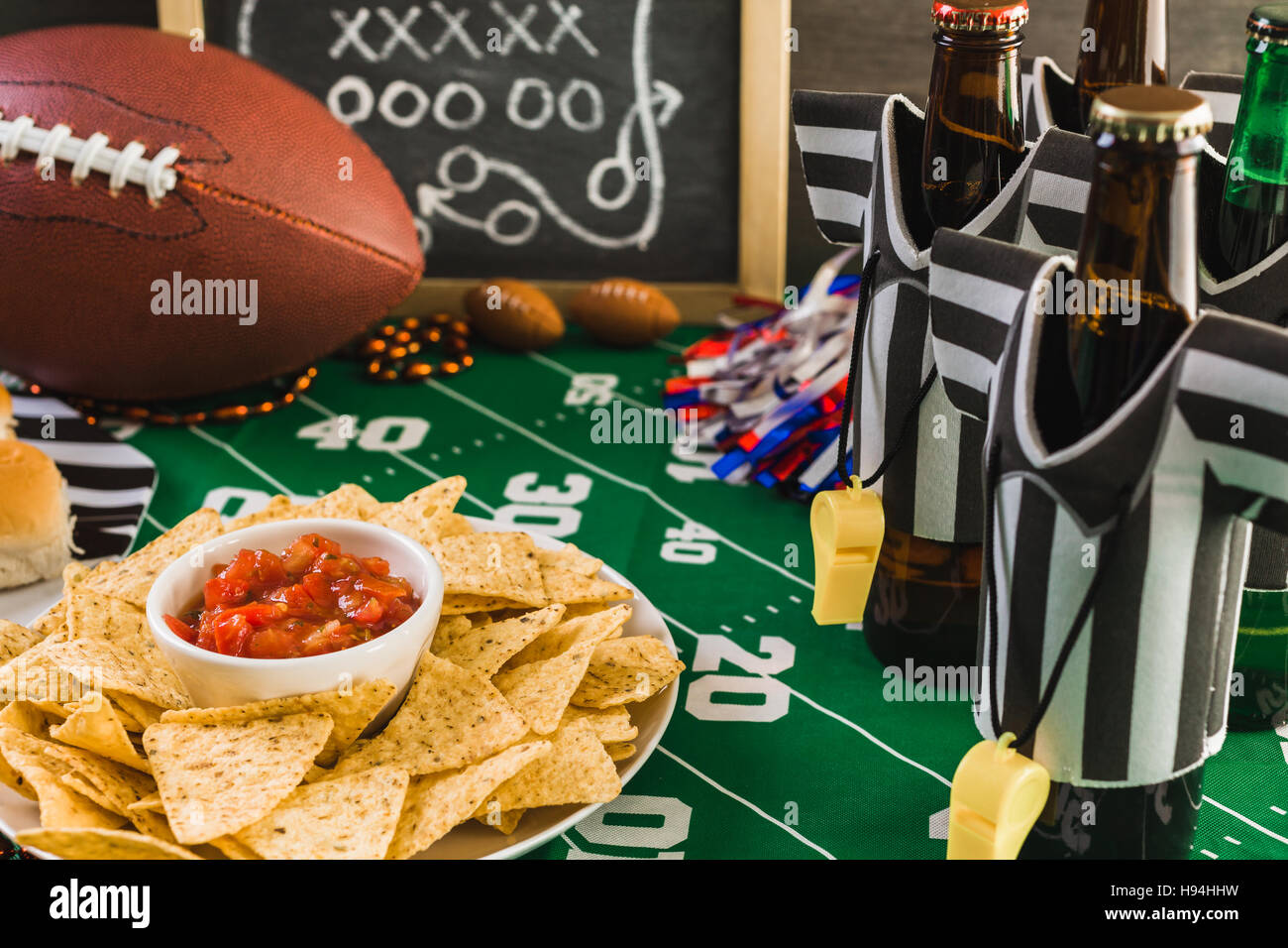 Game day football party table with beer, chips and salsa Stock Photo ...