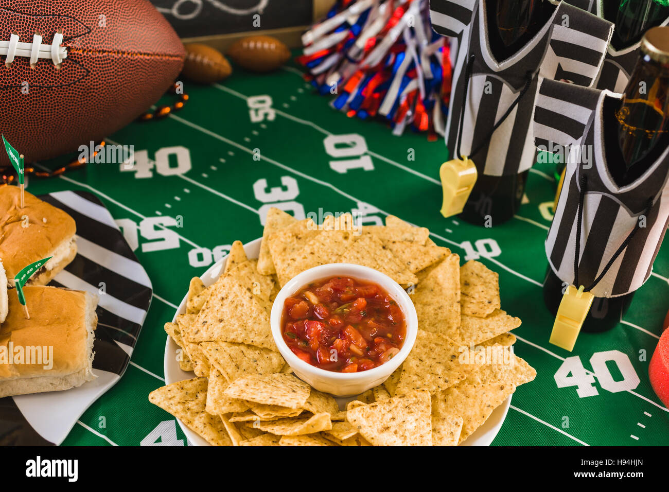 Game day football party table with beer, chips and salsa Stock Photo ...